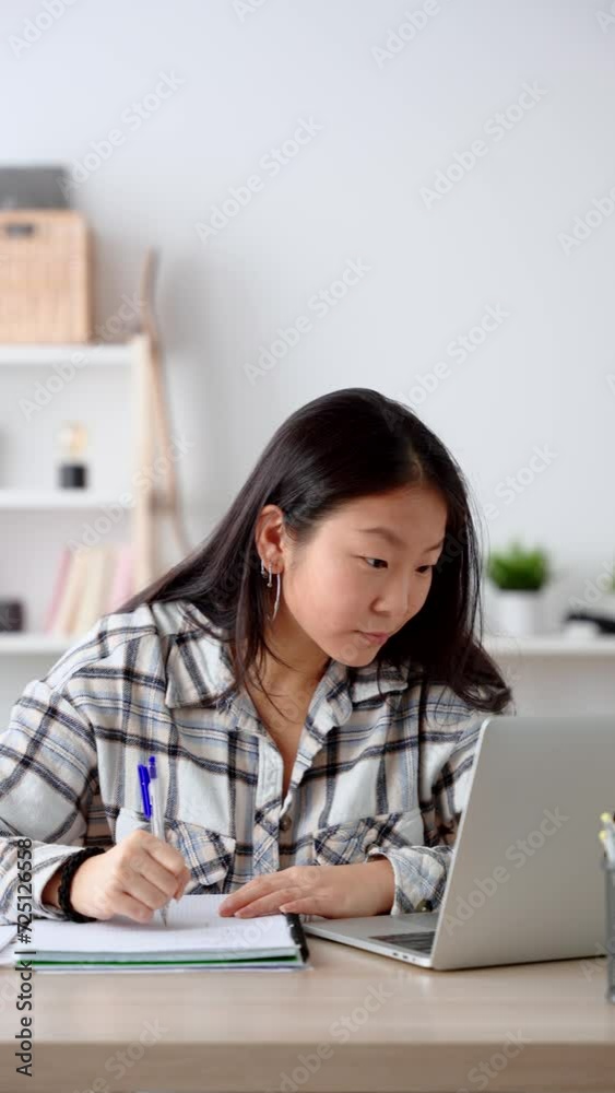 Vertical video of Chinese student learning from home. Young woman ...