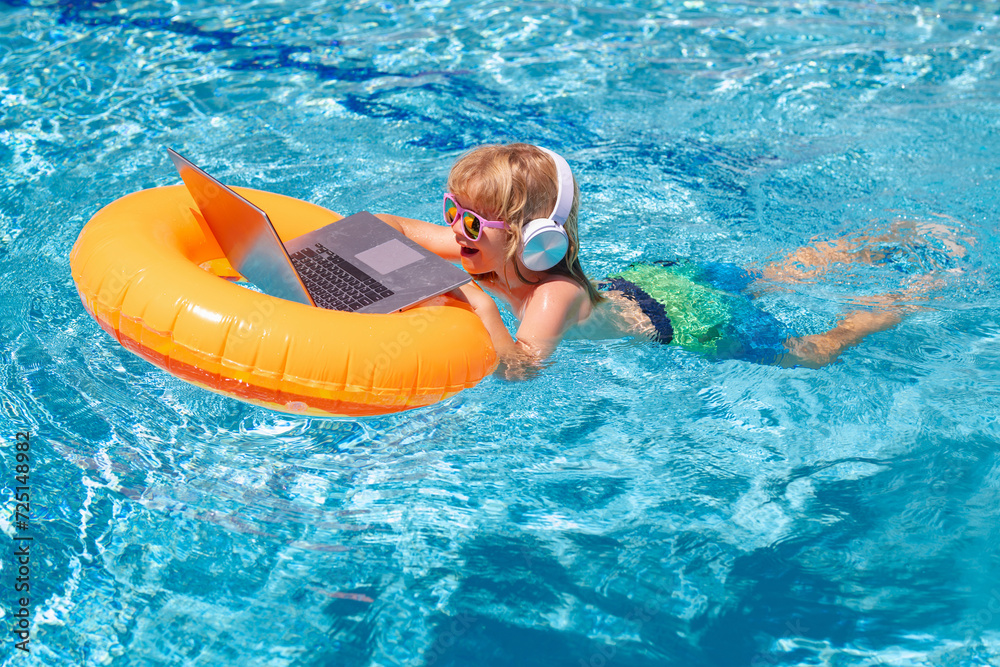 Work outside with laptop in pool. Child working on laptop from the ...