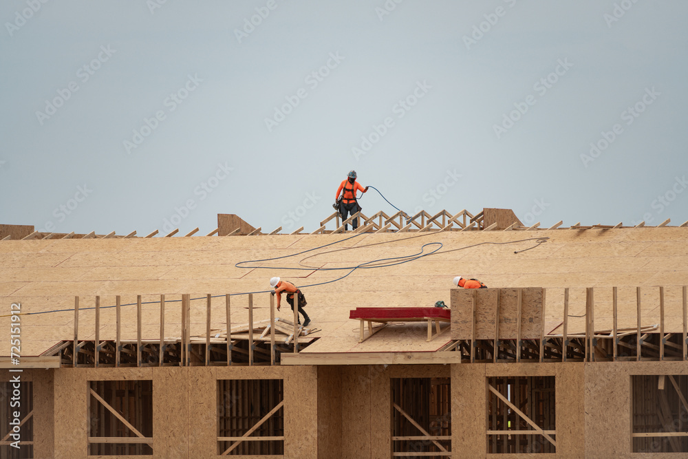 Roof construction. Roofer on roof structure. Construction Worker on Top ...