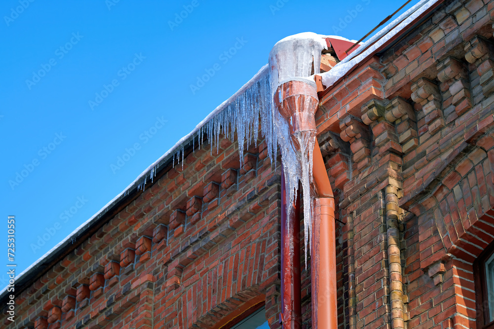 Ice dams, icicles hanging on gutter and rooftop on facade of historic ...