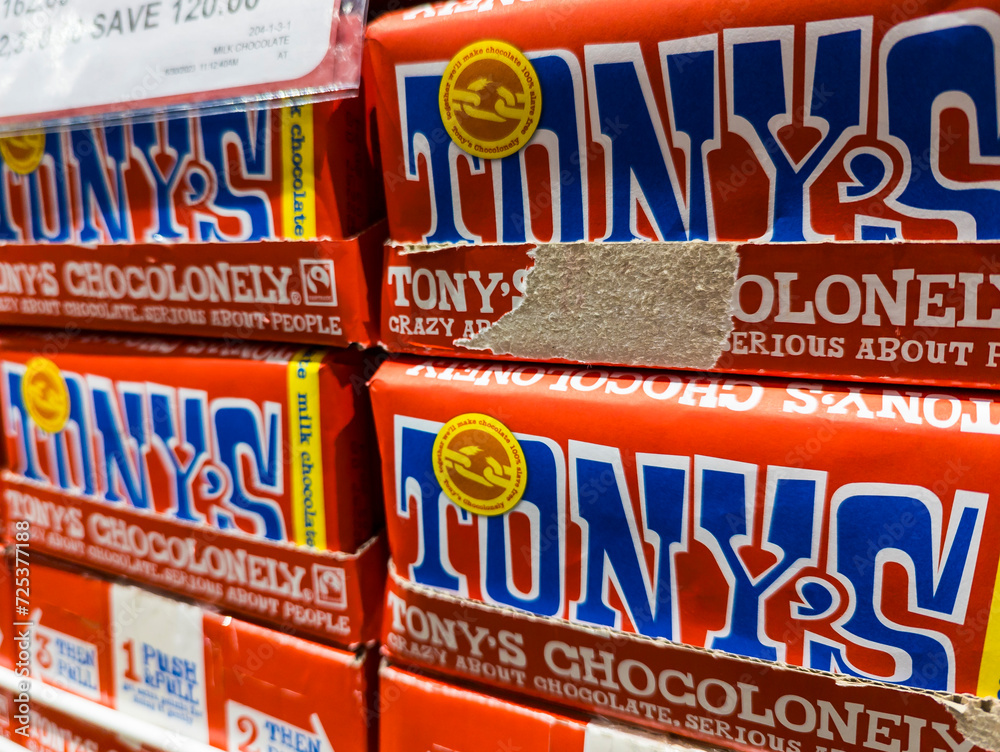 Rows of colorful Tony's Chocolonely chocolate bars on a store shelf ...