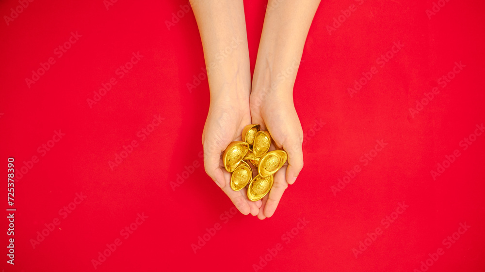 flat lay of hand holding a lot of ancient Chinese ingot gold bar out ...