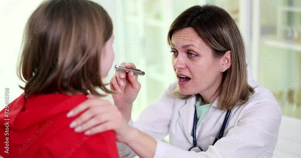 Doctor ENT examination of throat of child in clinic. Inflammation of ...