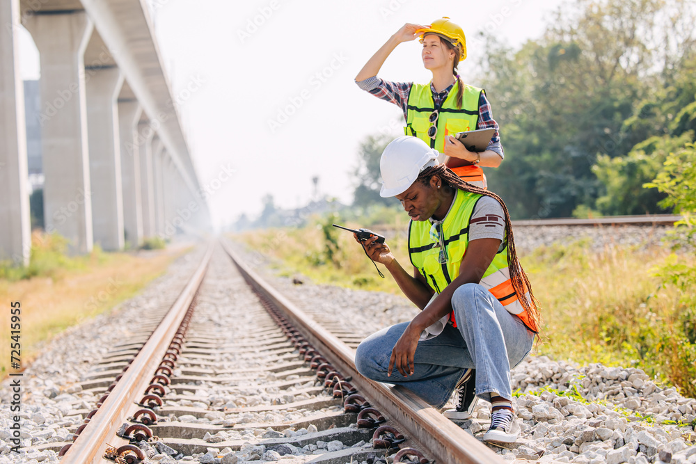 Engineer female railway tracks service team working on site survey ...