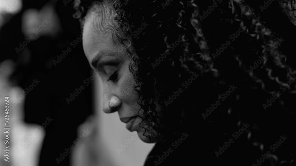 Desperate African American woman closing eyes in quiet despair in urban ...