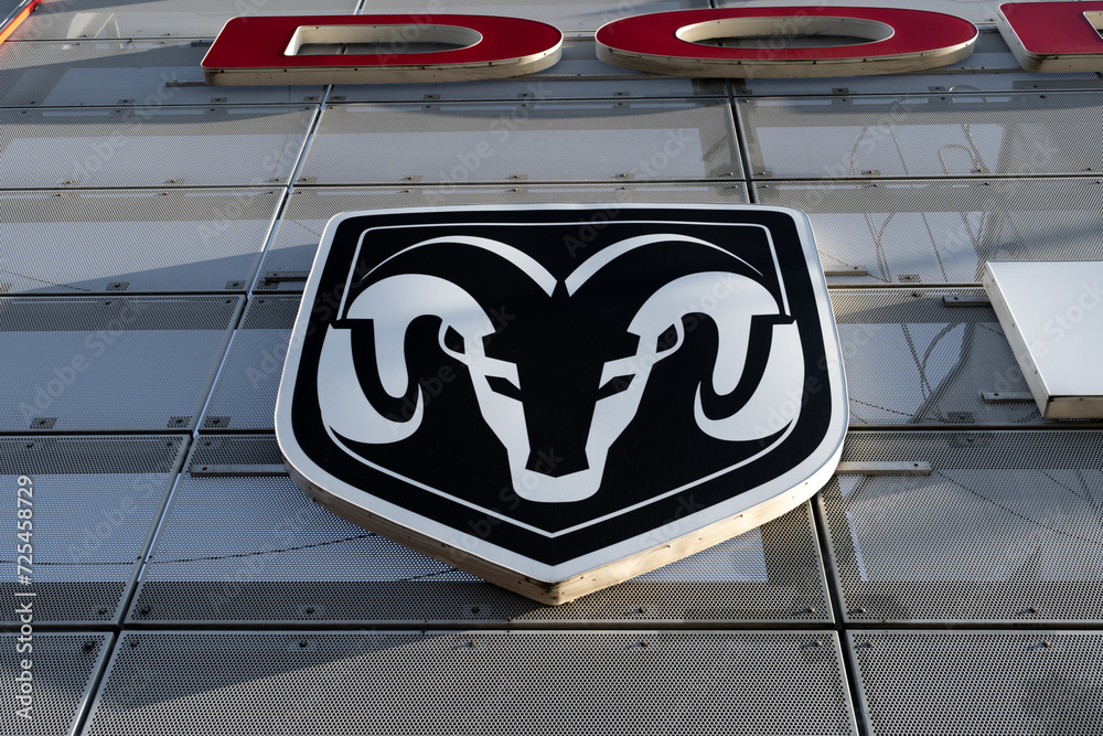 Ram Trucks logo sign on a car dealership building. American automobile ...