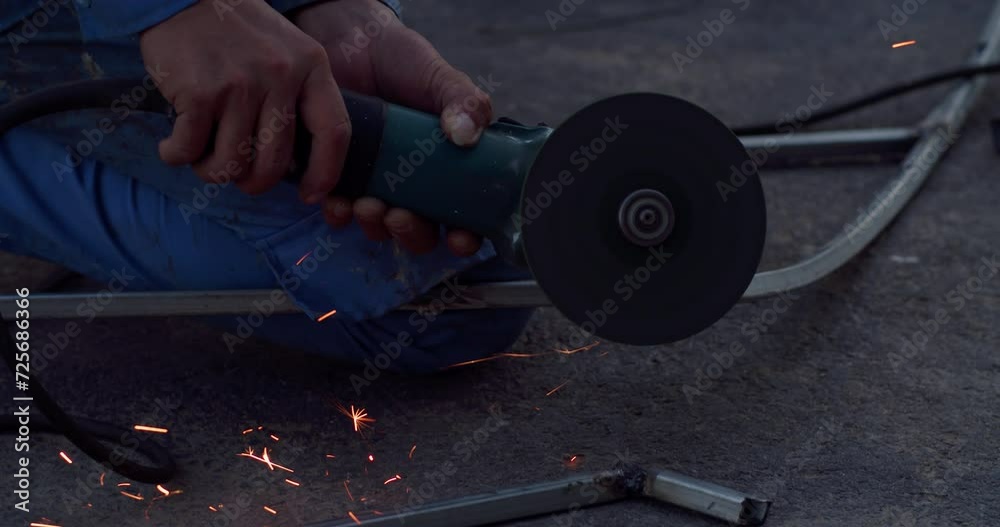 Blacksmith Cutting Metal Using Angle Grinder while Working in ...