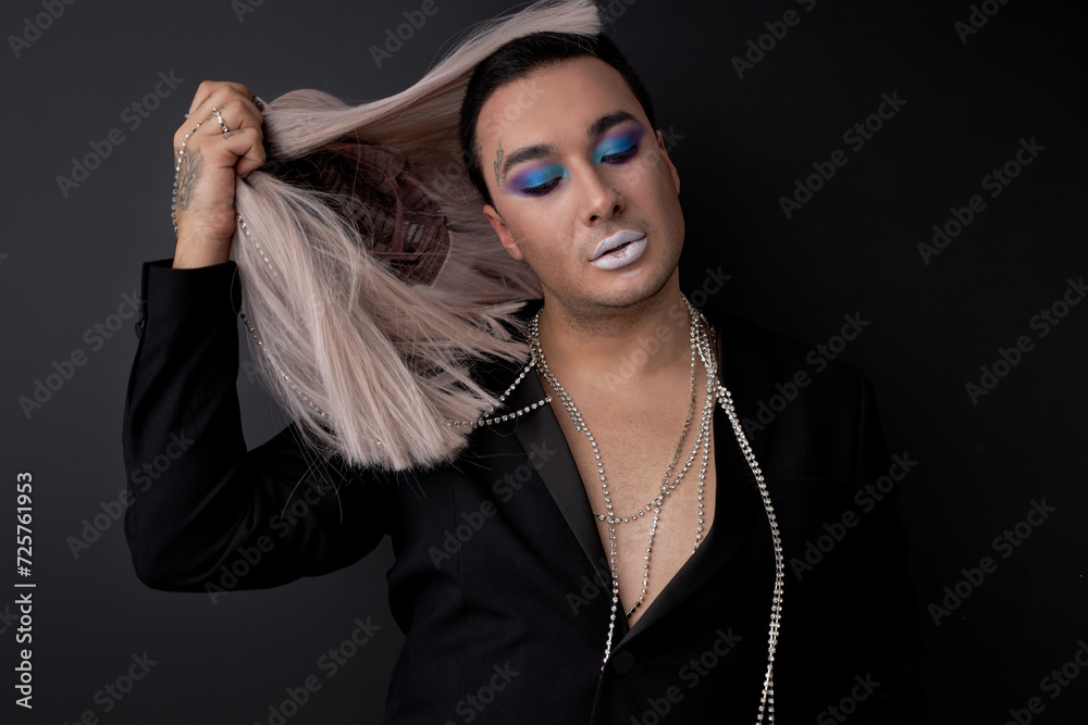 confident transvestite or gay take off the wig from head, man with make ...