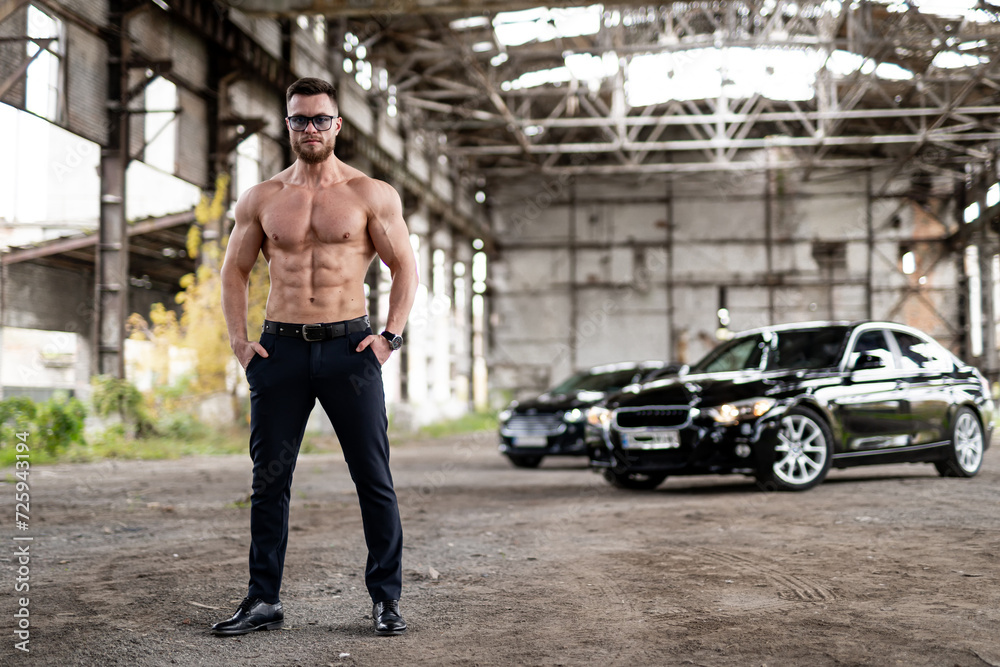 Handsome muscular man with six pack abs muscular body builder posing in ...