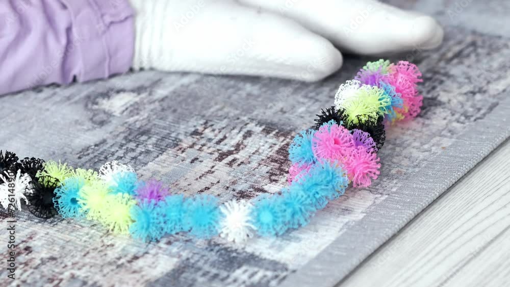 Video Stock The hands of a little girl playing bunches with a Velcro ...