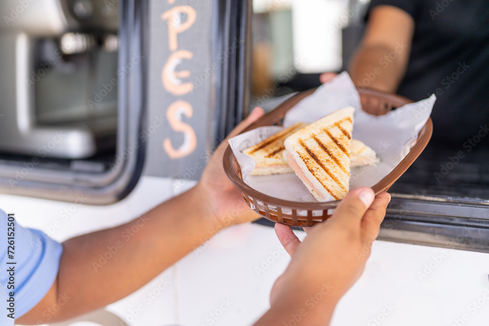 Serving a sandwich through the window of a food truck Stock Photo ...
