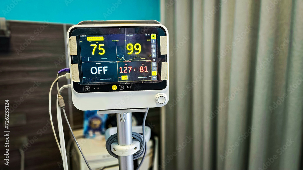 Vital signs monitor showing Heart rate and blood pressure of patient in ...