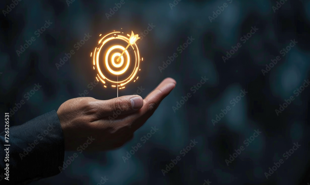 Hand holding Target icon which for planning development leadership and ...