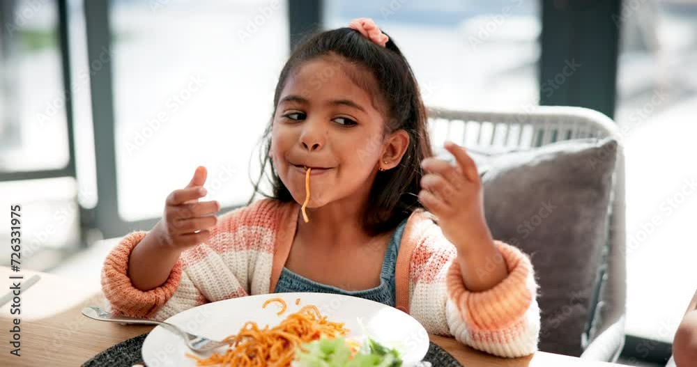 Girl, child and eating spaghetti in home, hungry and lunch with ...