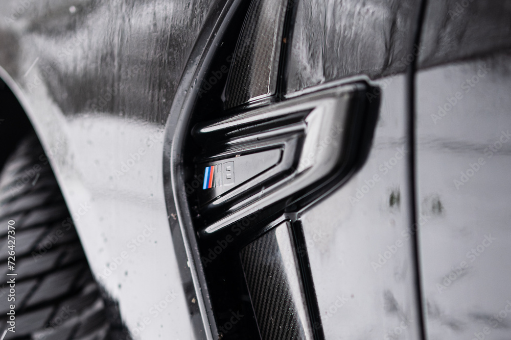 BMW M 8 lettering, logo on the fender of a new black BMW M8 in the snow ...