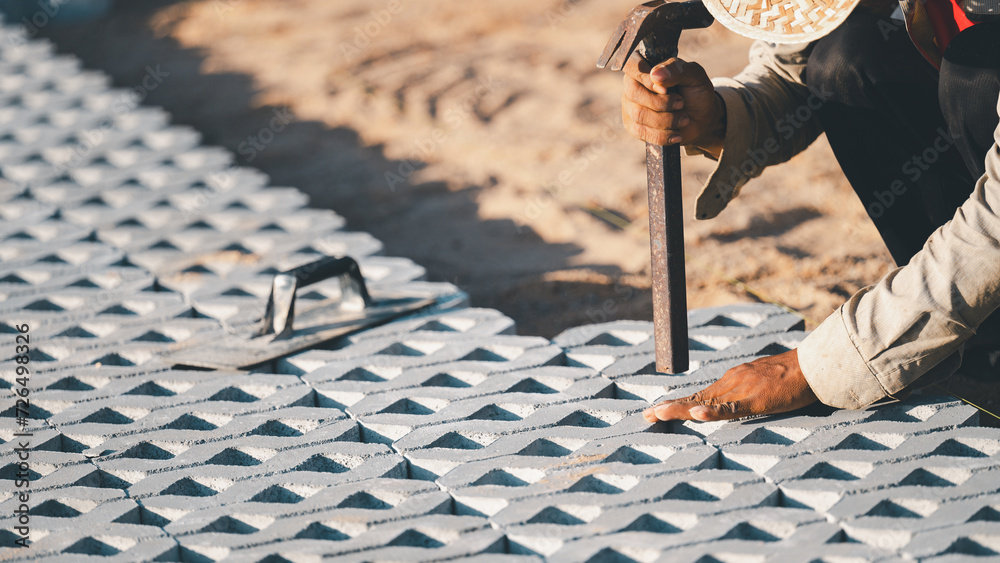 Installing paving blocks concept. Diligent man engages in outdoor ...