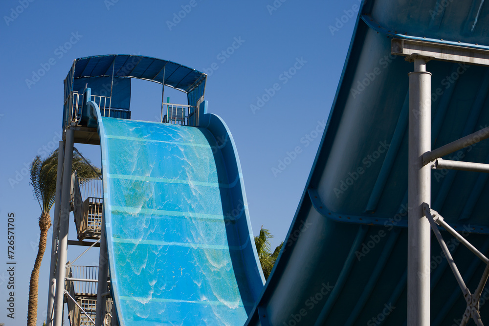 Water slide with a sharp descent in an outdoor aquapark. Extreme free ...