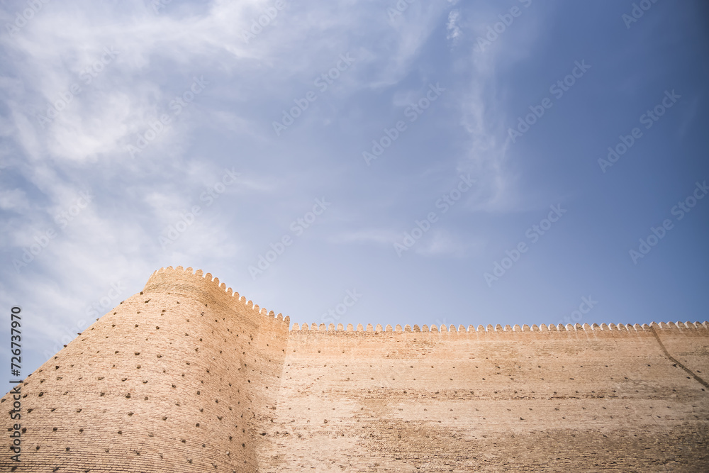 Ark Citadel with brick fortress walls in the ancient city of Bukhara in ...