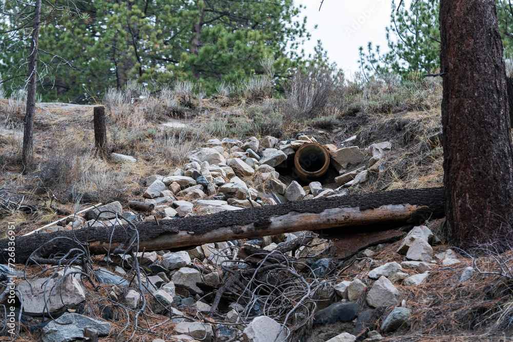 Highway culvert pipe outlet underneath road with rocks below. Stock ...