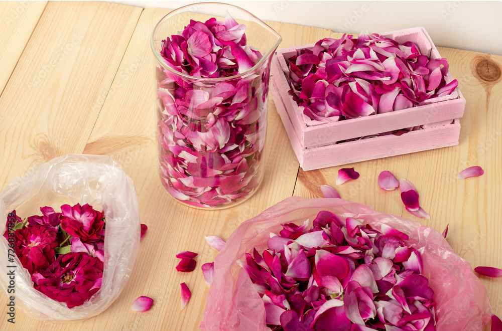 Damask rose petals in cylindrical glass flask, in wooden box, and in ...