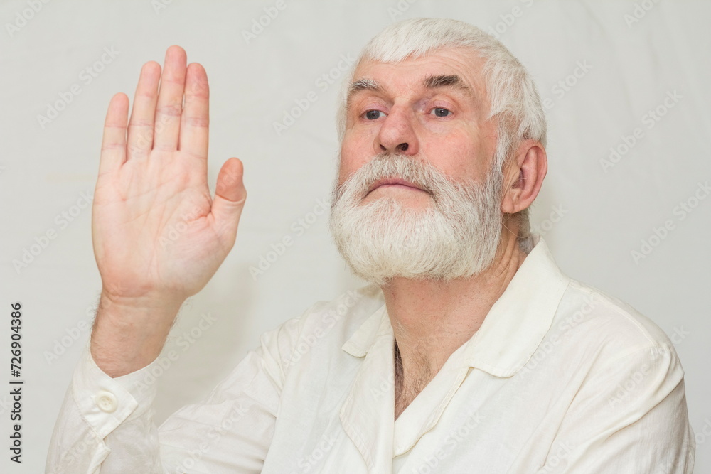 elderly man doctor shows hand palm forward, gesture everything is fine ...