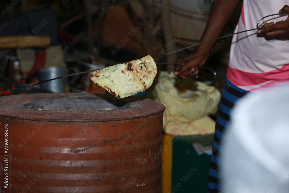 preparation of food in indian kitchen- roti, nan, paratha an indian ...