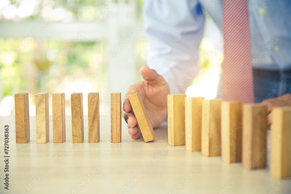 Hand to stop wooden block prevent not falling domino concepts of ...