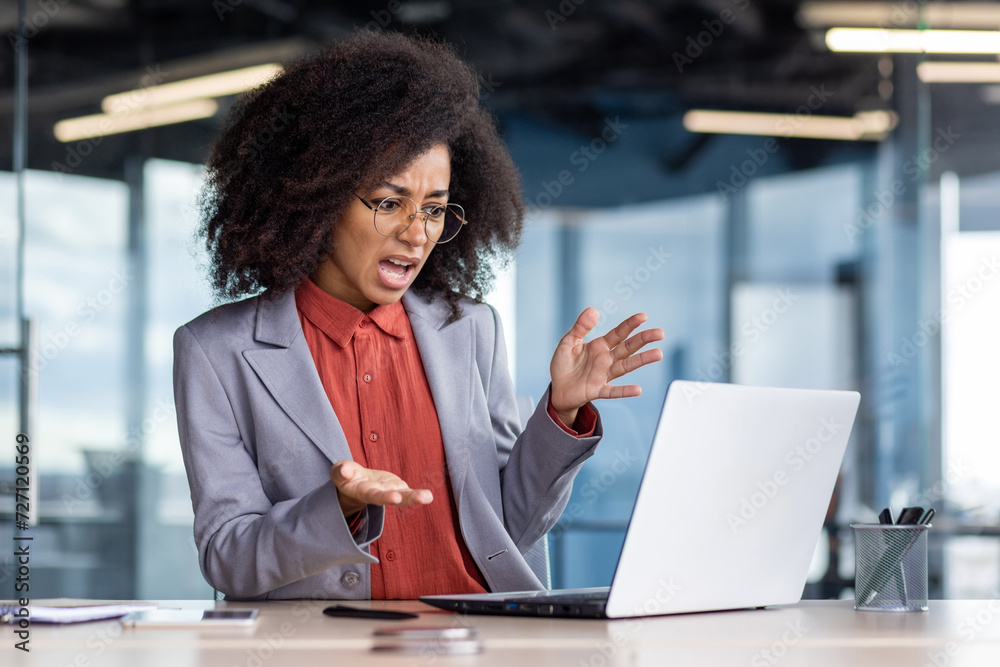 Angry businesswoman yelling at workplace inside office, woman received ...