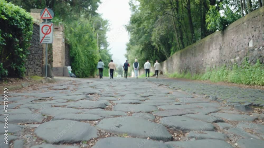 Blurred group of people walking along the oldest Roman road on via ...