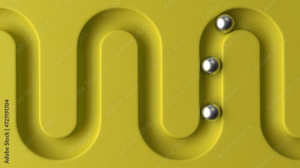 Cycled minimal animation. Metal balls rolling in geometry deepening ...