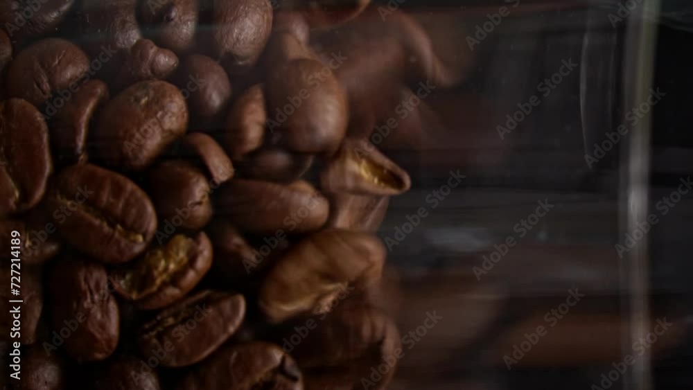 Coffee beans fall in slow motion and cover the entire screen. Roasted ...