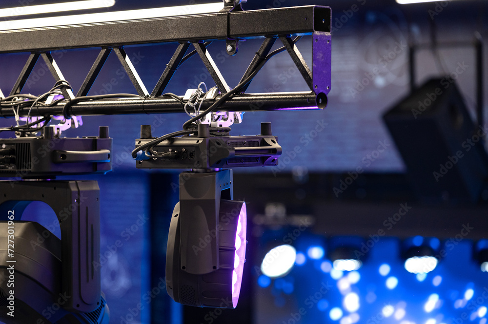modern lighting equipment on a suspended truss. professional lighting ...