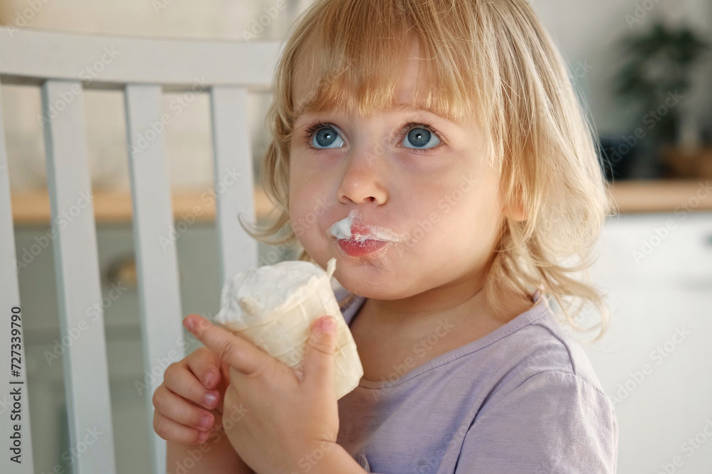 Baby girl enjoying ice cream. Pretty little toddler eating an ice-cream ...