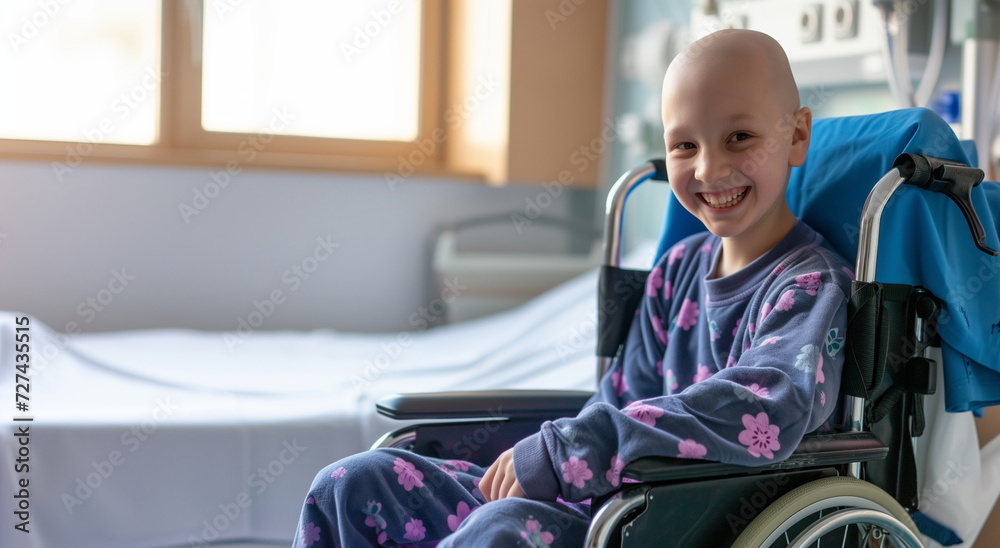 Smiling bald child cancer patient in wheelchair. World Cancer Day ...