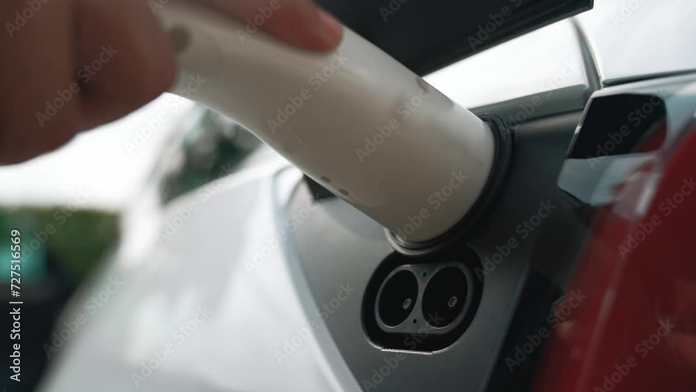 Vidéo Stock Closeup EV charger plug holder connect to electric car ...