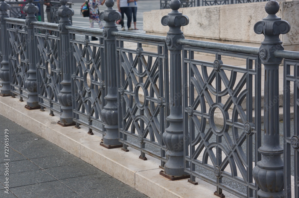 Perspective of black metal barrier. Road.Iron small pillars decorating ...