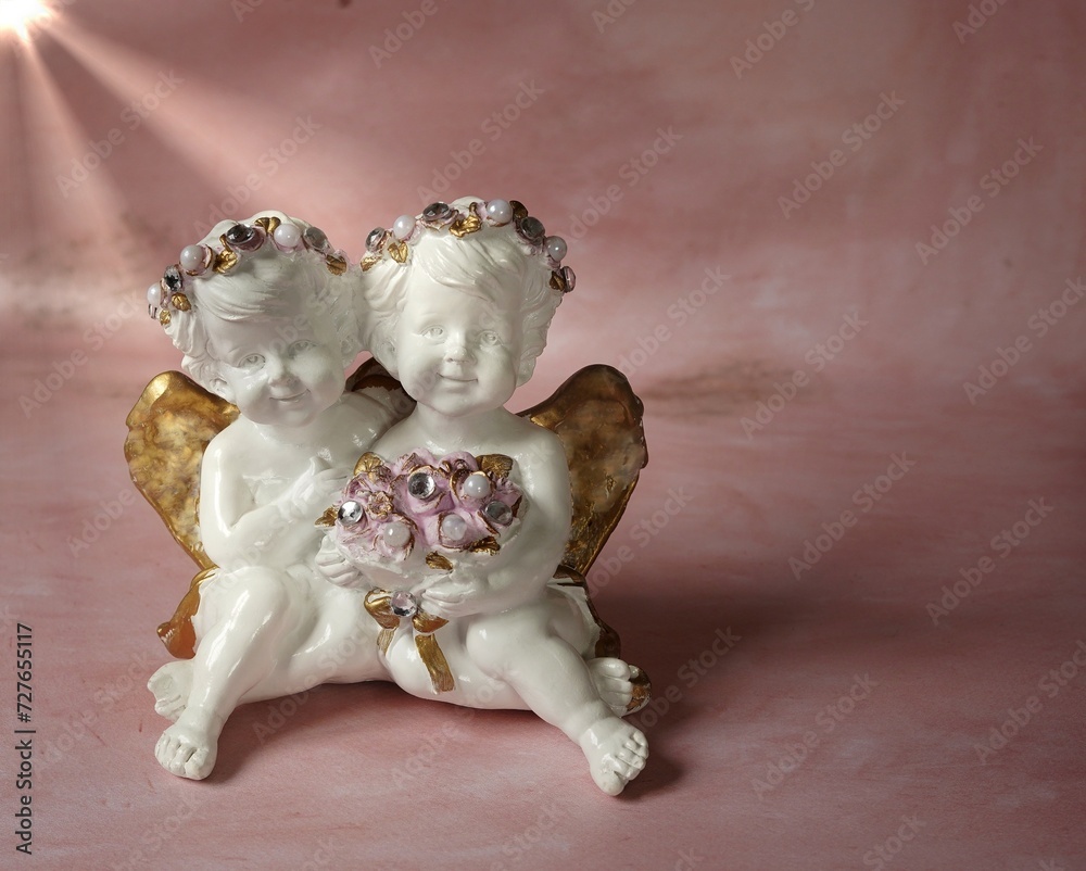 Two small porcelain angels with royal wings and a wreath on their heads ...