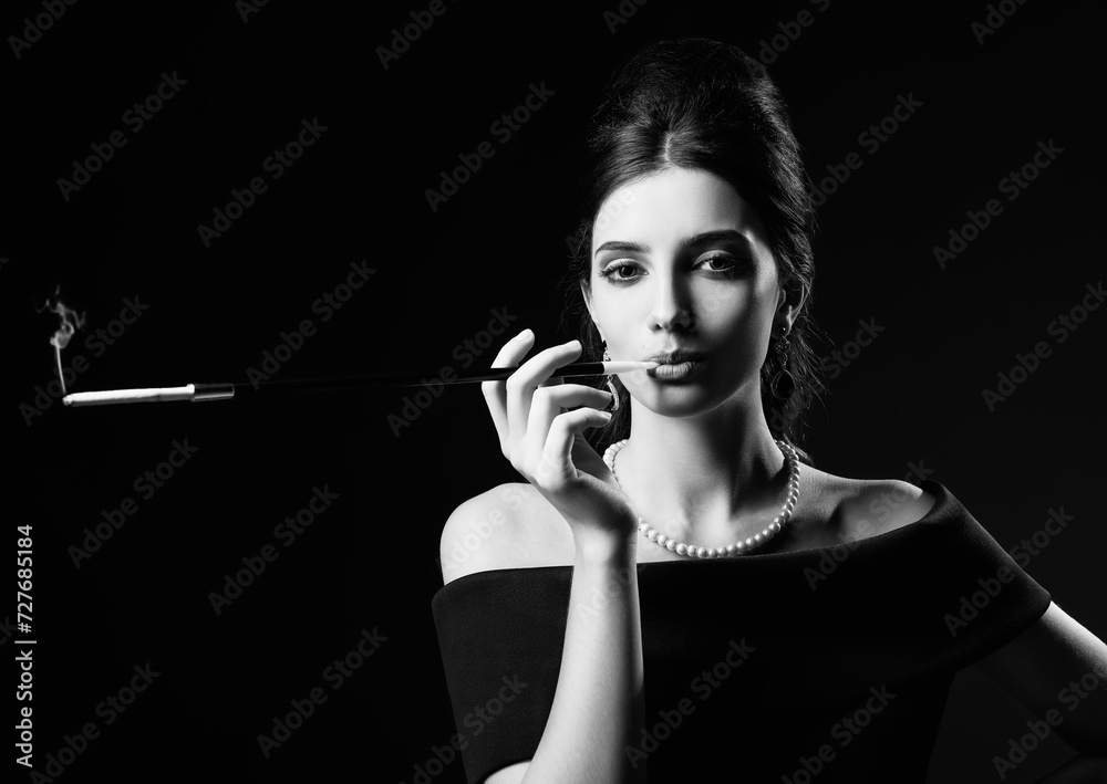 Retro shot: beautiful young woman smoking cigarette. Vintage portrait of posh girl in 60s style ...