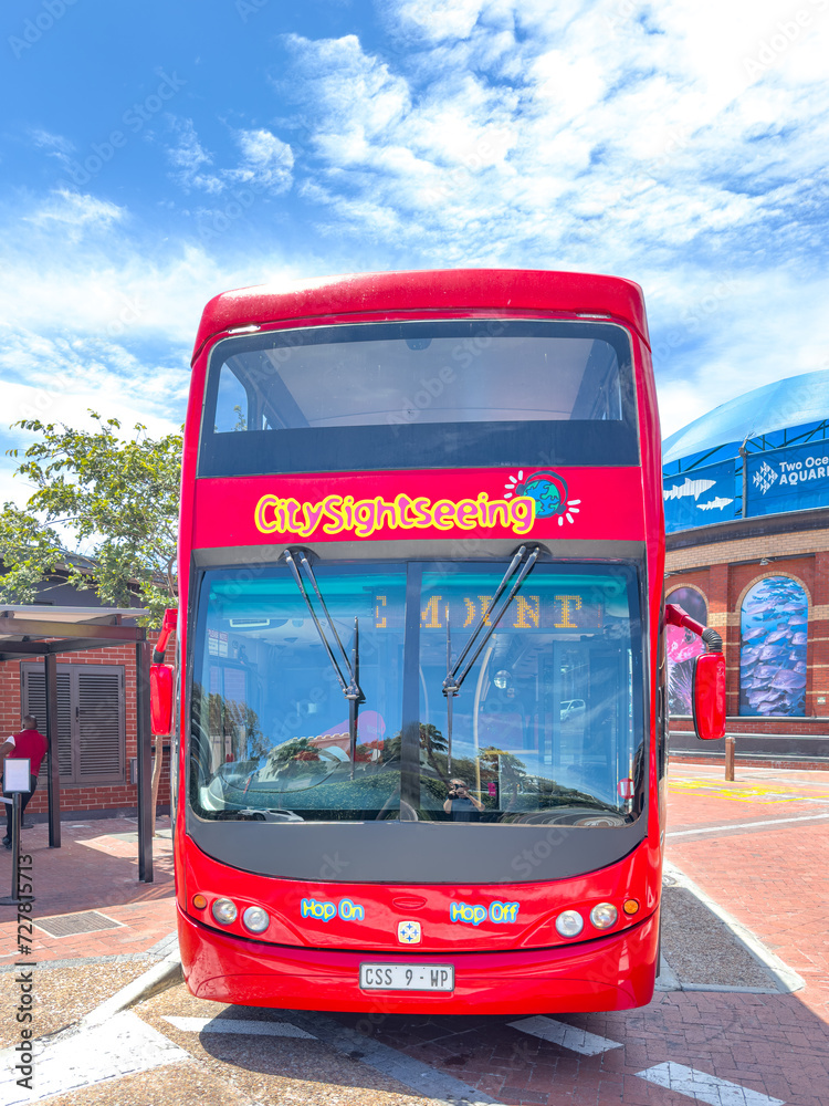 A red open top Cape Town sightseeing bus at the Victoria and Alfred ...