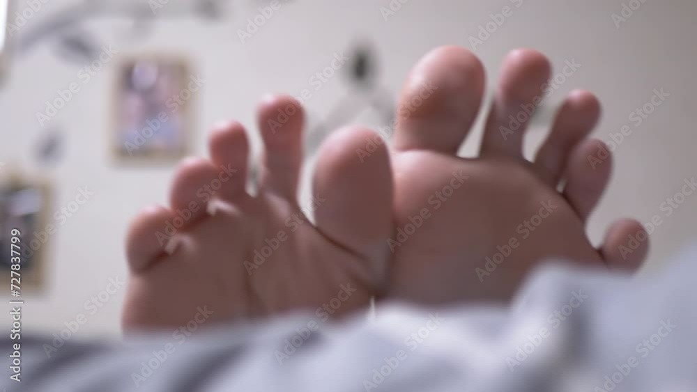 Vidéo Stock Close up, Person Moves Tired Legs in Pajamas on the Bed in ...