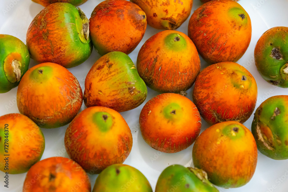Rare and exotic fruit of the peach palm (Bactris gasipaes), typical ...