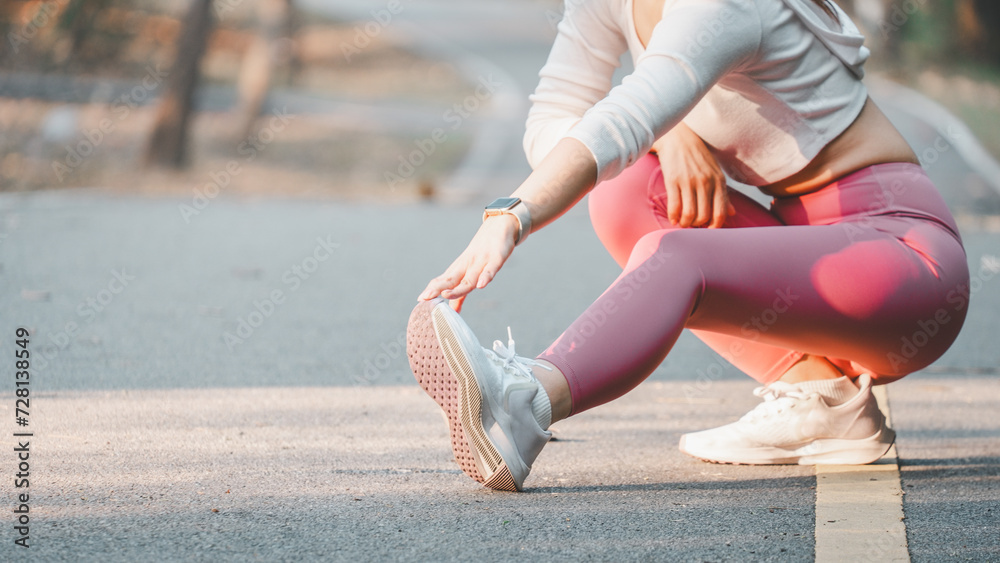 Running concept, Close-up of a woman's legs as she performs a toe-touch ...