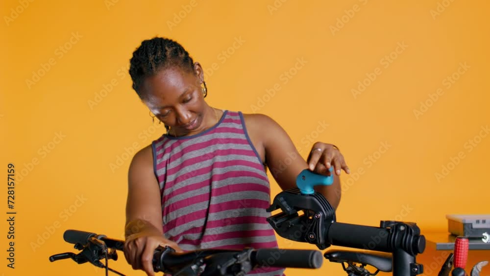 African american woman setting up bike repair stand, using it to adjust ...