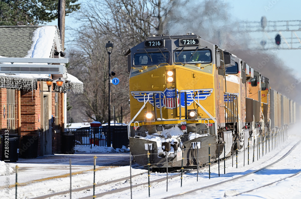 Locomotives lead a Union Pacific Railroad freight train past a commuter ...