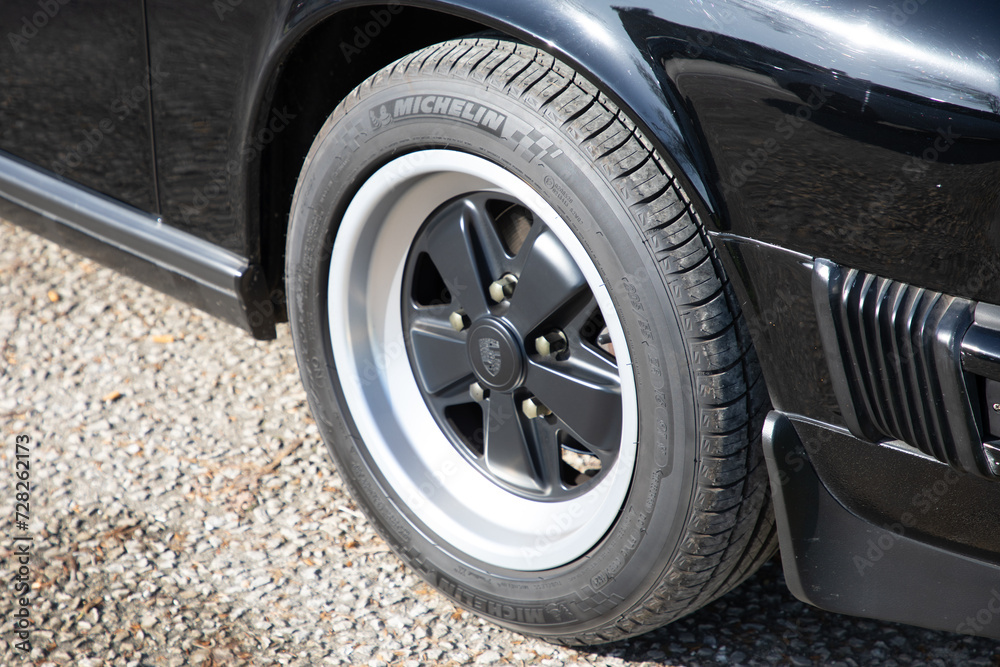porsche logo sign on front fush wheel and michelin text brand tyre on ...