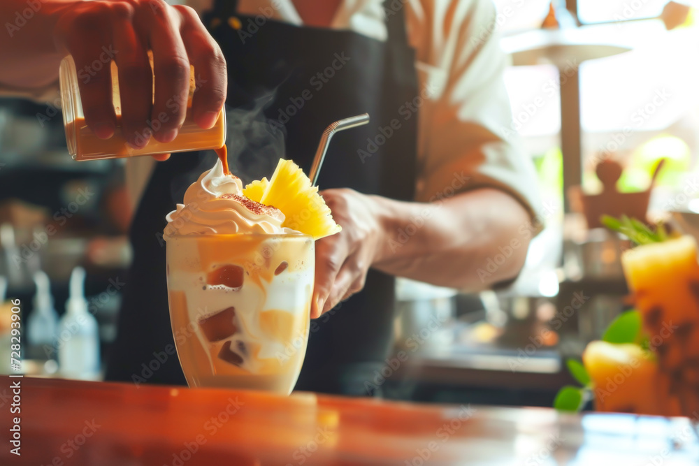 Barista topping a tropical latte with generous swirl of whipped cream ...