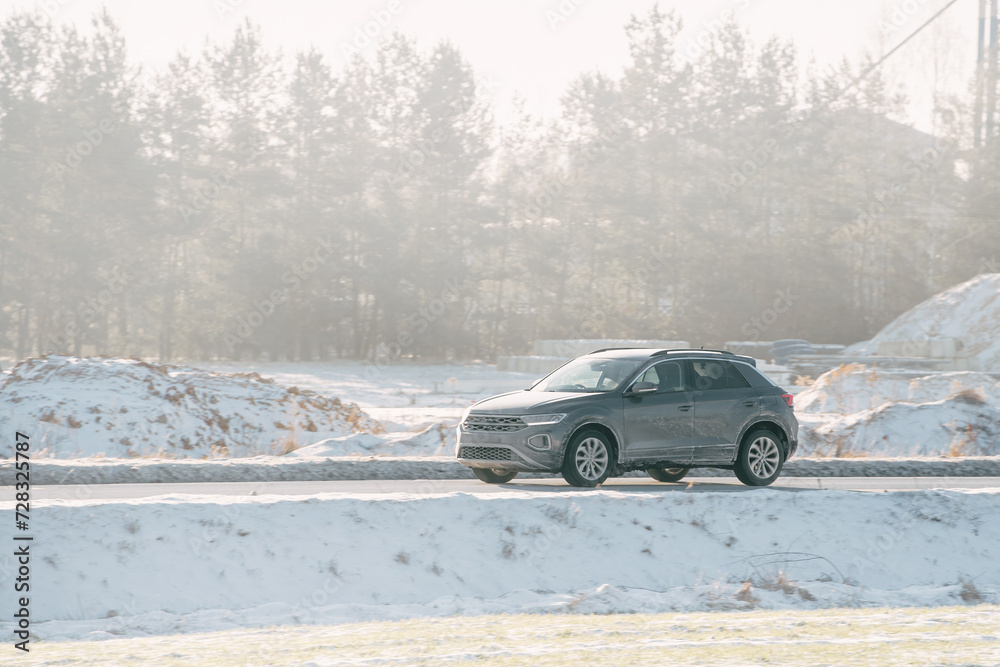 A car covered with salt on an icy road. The vehicle shows signs of ...