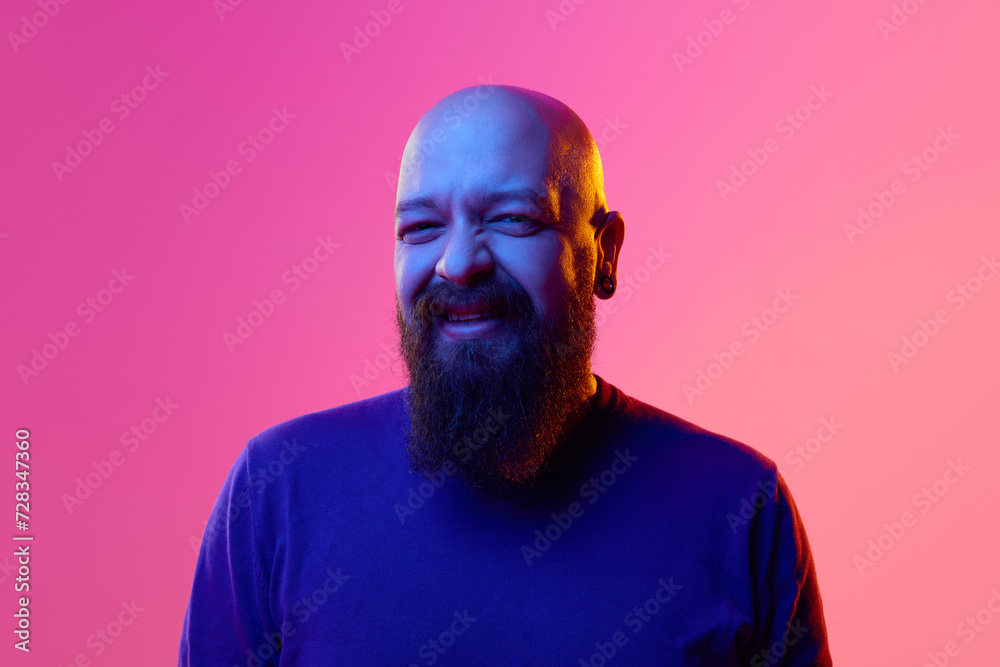 Gel portrait of bearded bald man in his 30s wearing blue sweater ...