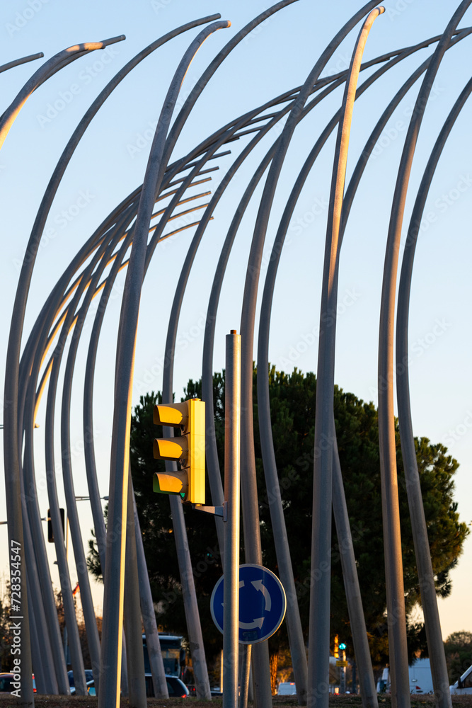 Yellow traffic light at an intersection in the middle of a cityscape in ...
