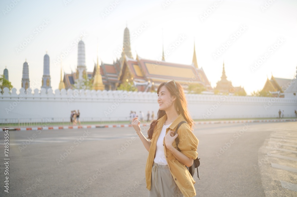 Traveler asian woman in her 30s, backpack slung over her shoulder ...